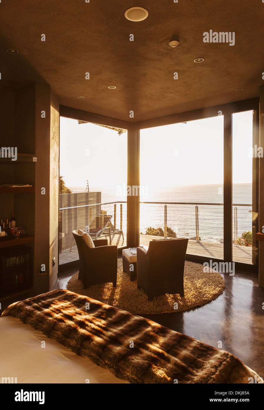 Luxury bedroom overlooking ocean at sunset Stock Photo - Alamy
