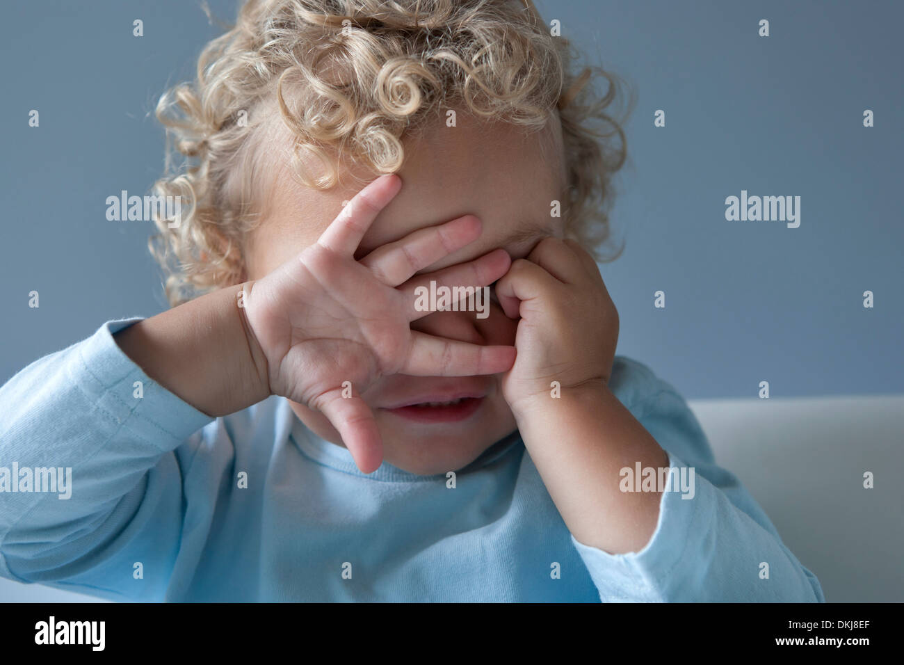 Sad toddler boy with hands for his eyes Stock Photo - Alamy