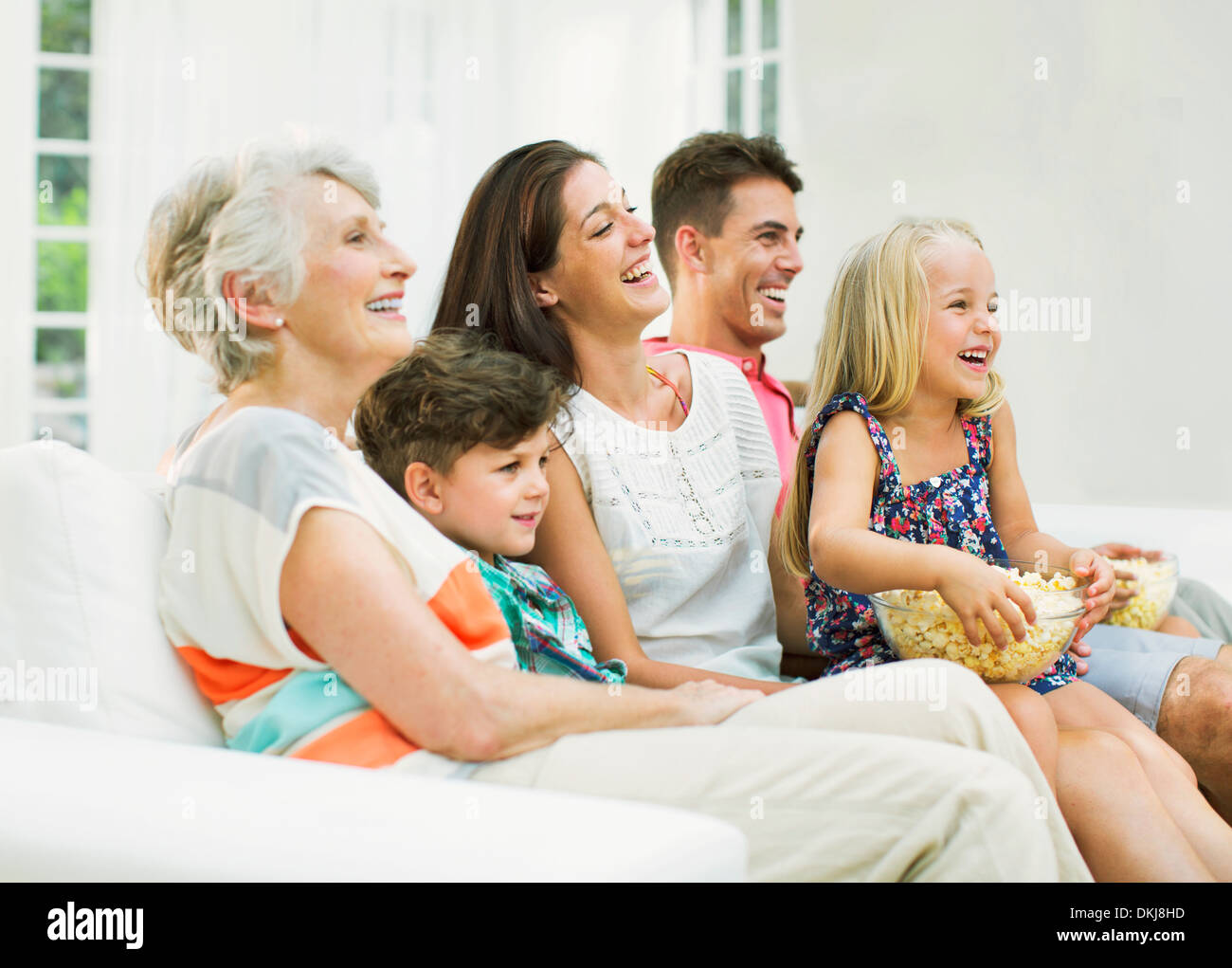 Family watching television together Stock Photo - Alamy