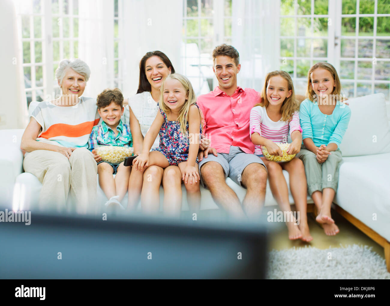 Senior couple watching tv with children hi-res stock photography and ...