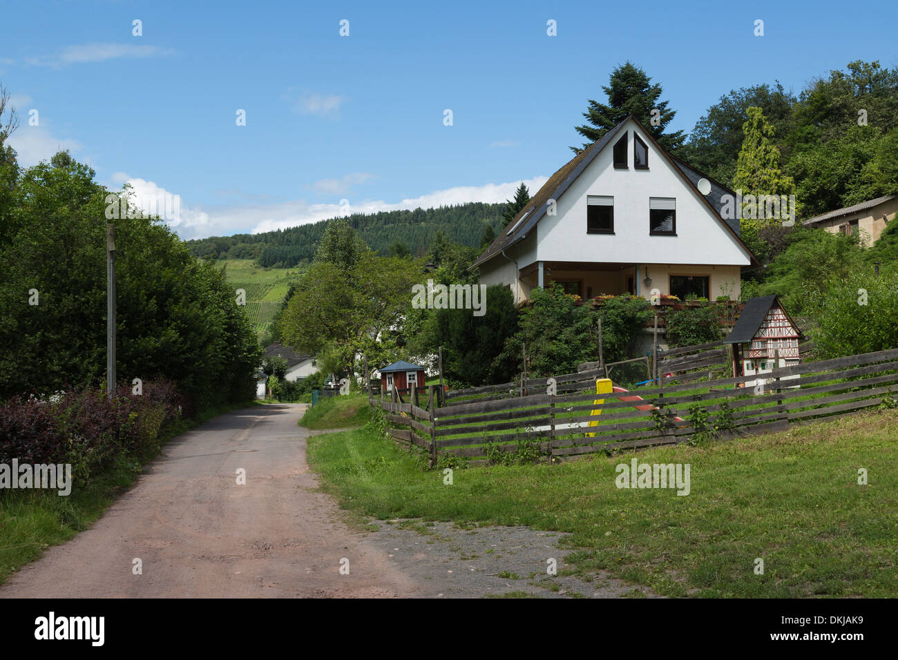 Small road with houses in hilly country Stock Photo - Alamy