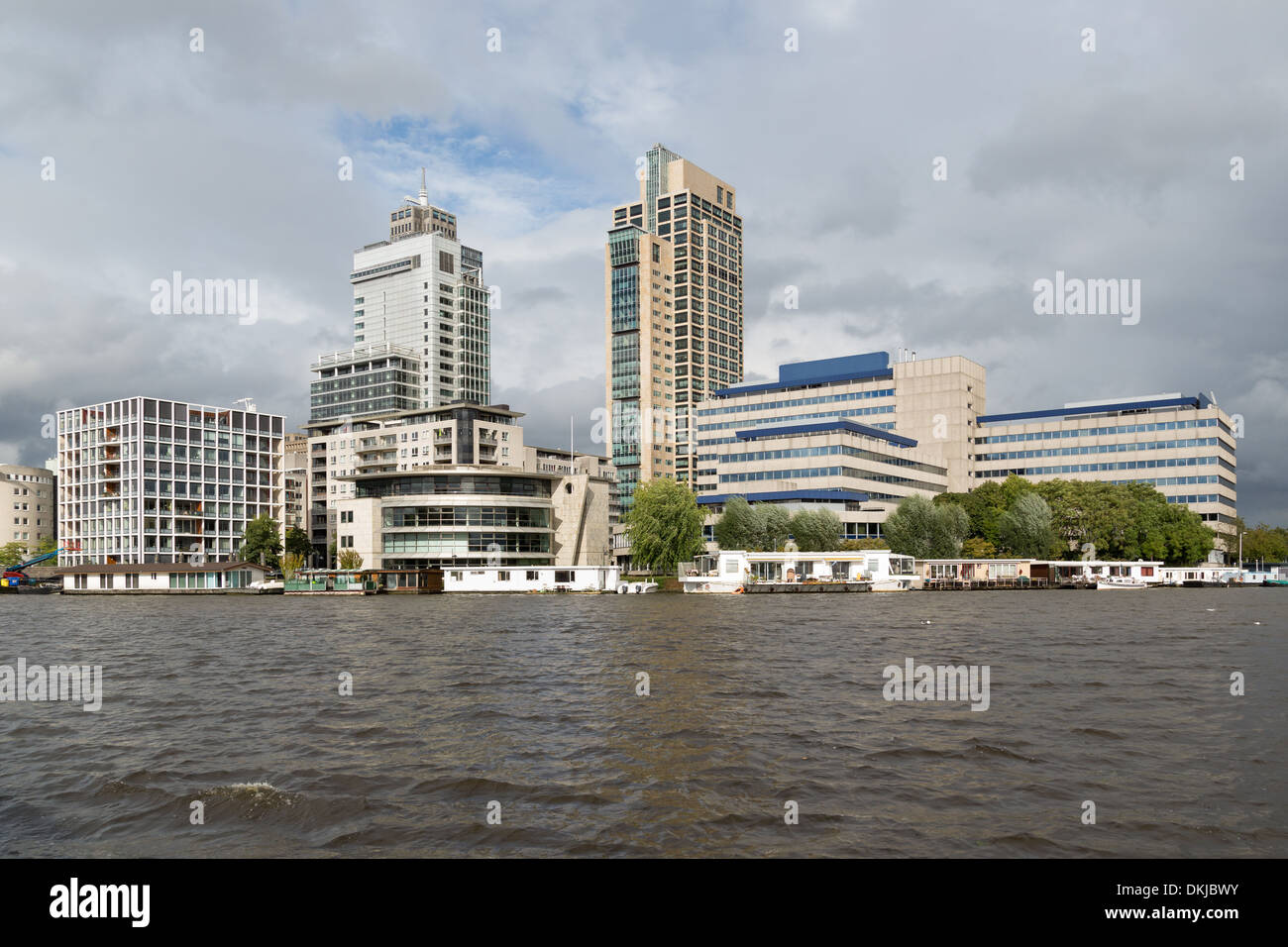 Amsterdam office buildings along the river Amstel in The Netherlands ...
