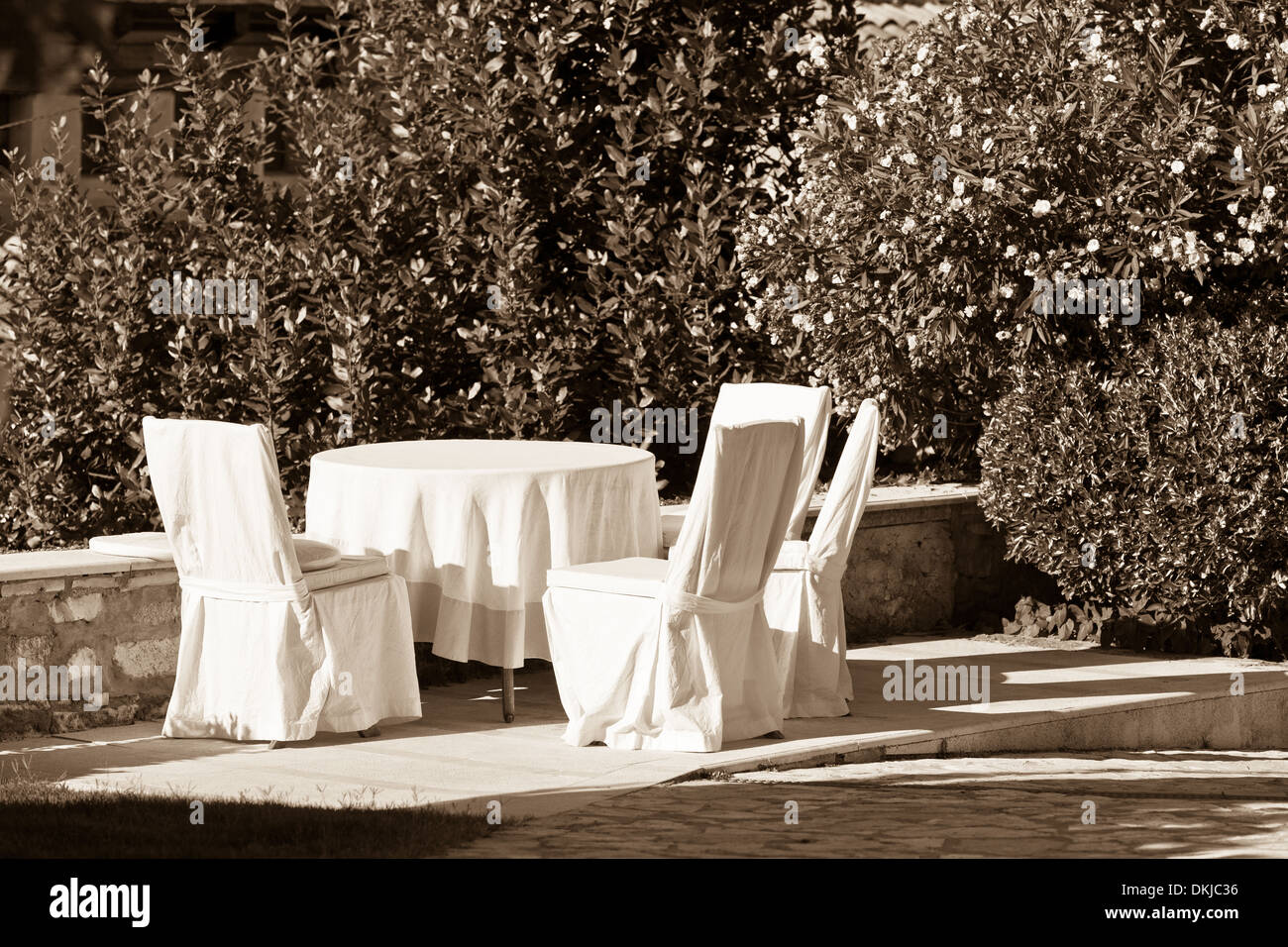 Outdoor empty summer cafe table with chairs. Sepia Stock Photo - Alamy