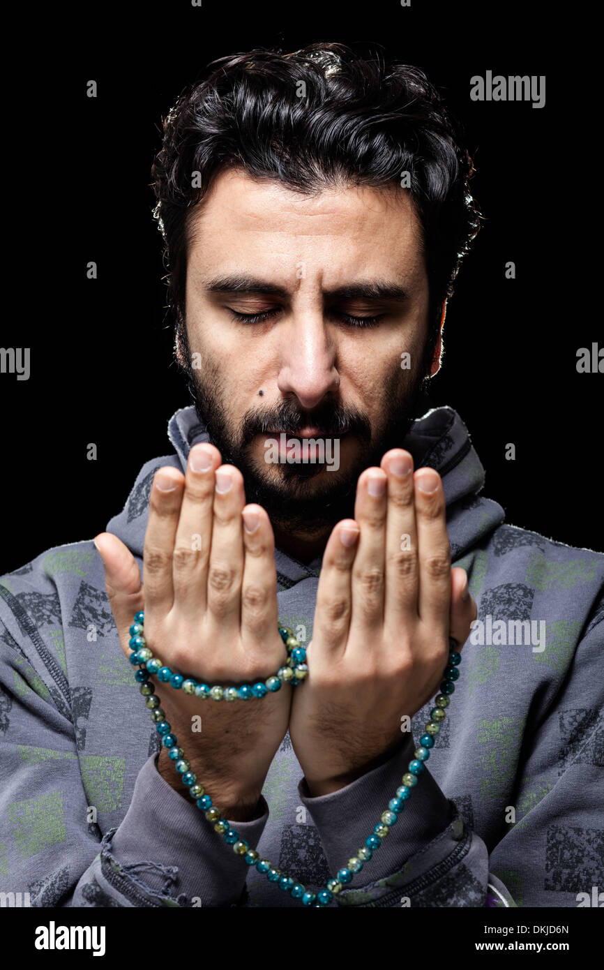 Western Muslim Praying with Tasbih Stock Photo - Alamy