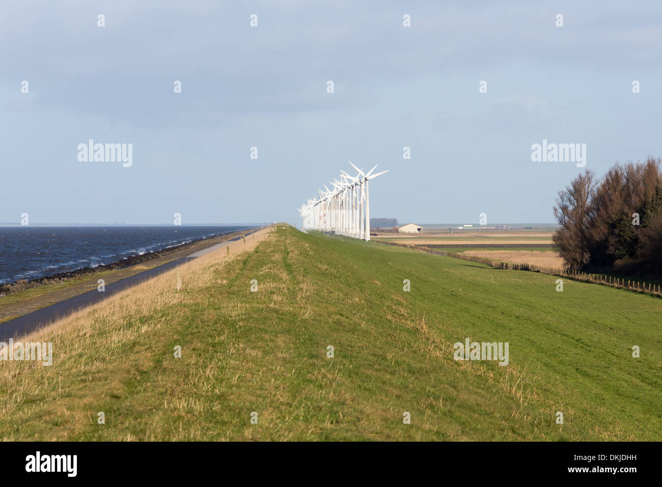 Dutch wind turbines along a straight dike Stock Photo - Alamy