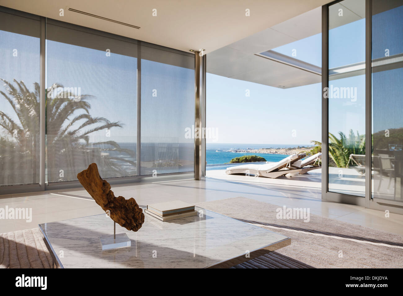Modern living room and patio overlooking ocean Stock Photo - Alamy