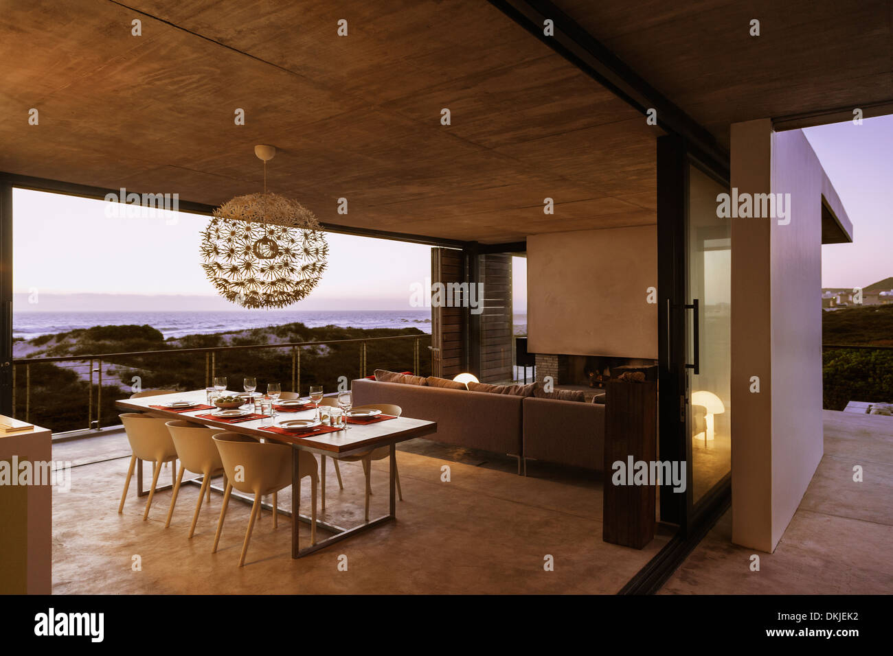 Modern house overlooking ocean at sunset Stock Photo - Alamy