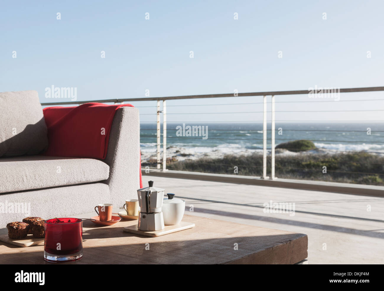 Breakfast on coffee table on modern patio overlooking ocean Stock Photo ...