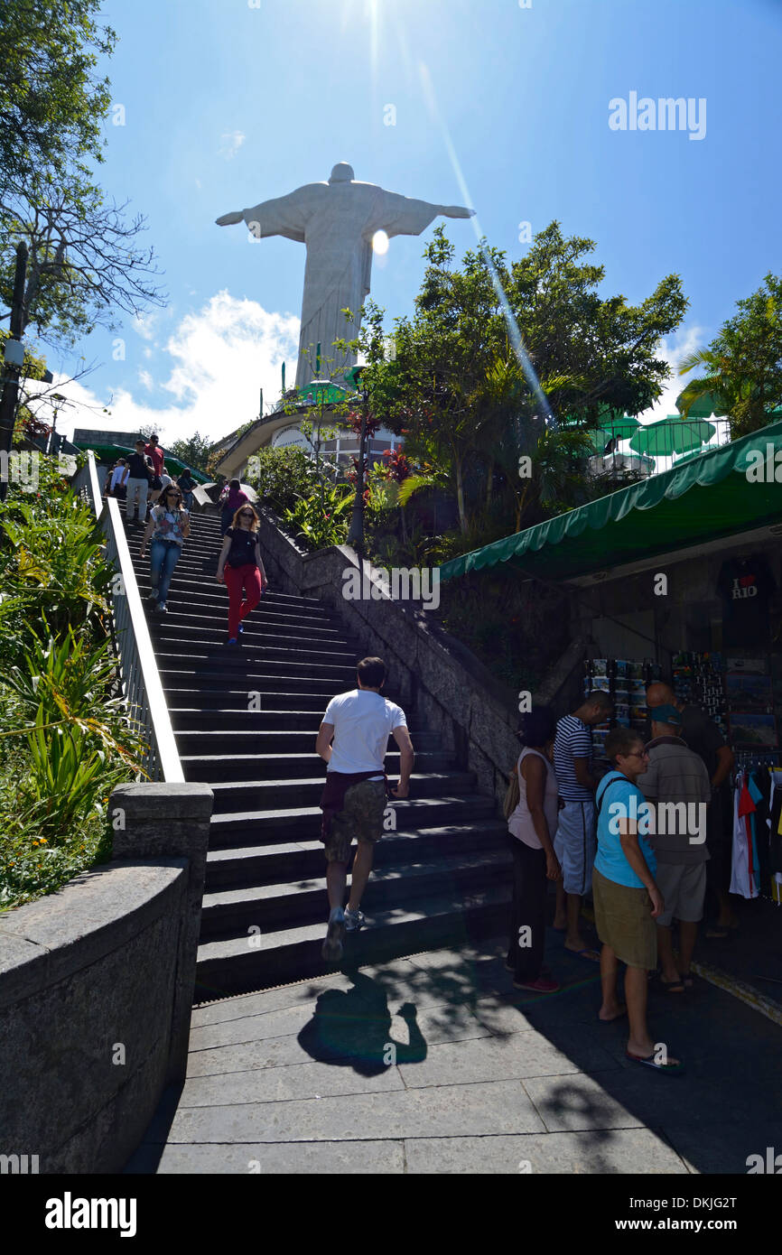A group of tourists climbing the steps towards Christ the Redeemer is ...
