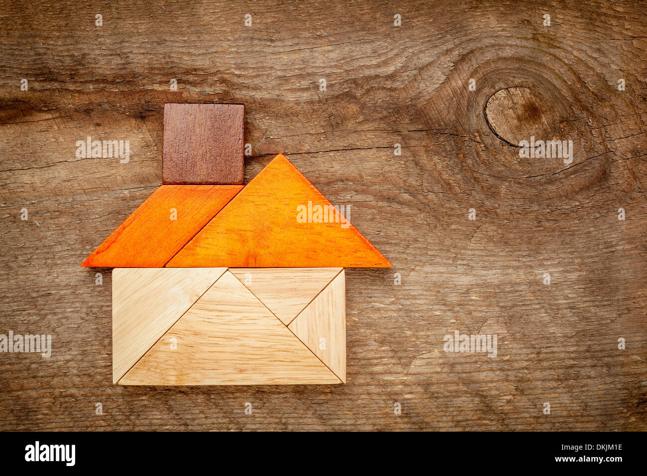 abstract picture of a house built from seven tangram wooden pieces, a ...