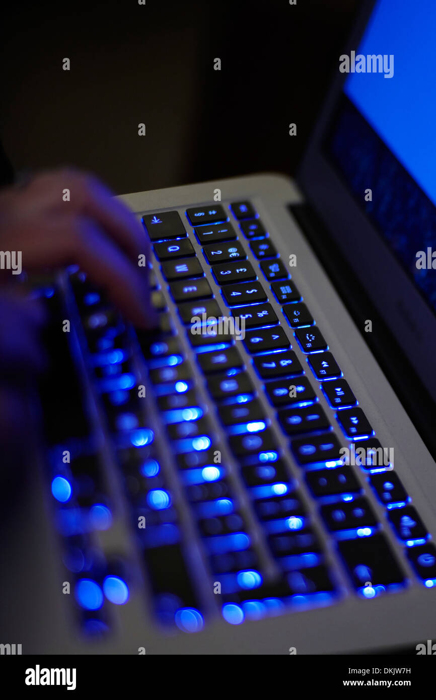 Laptop computer being used at night Stock Photo - Alamy