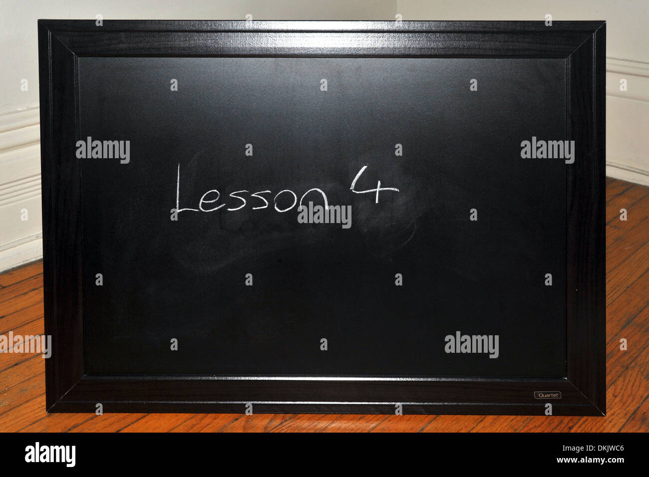 A blackboard with the word lesson 4 written on it in white chalk Stock ...