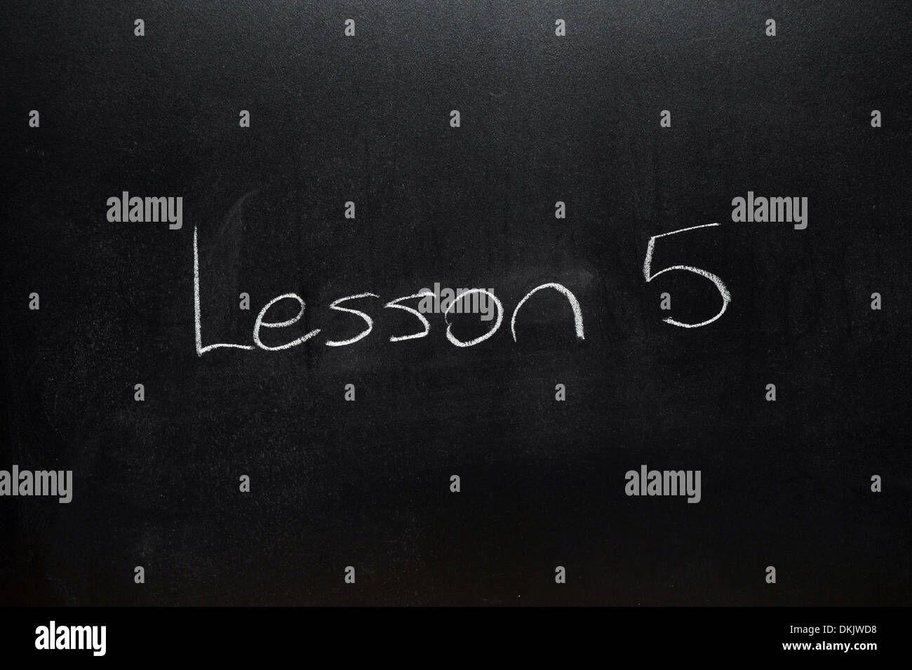A blackboard with the word lesson 5 written on it in white chalk Stock ...