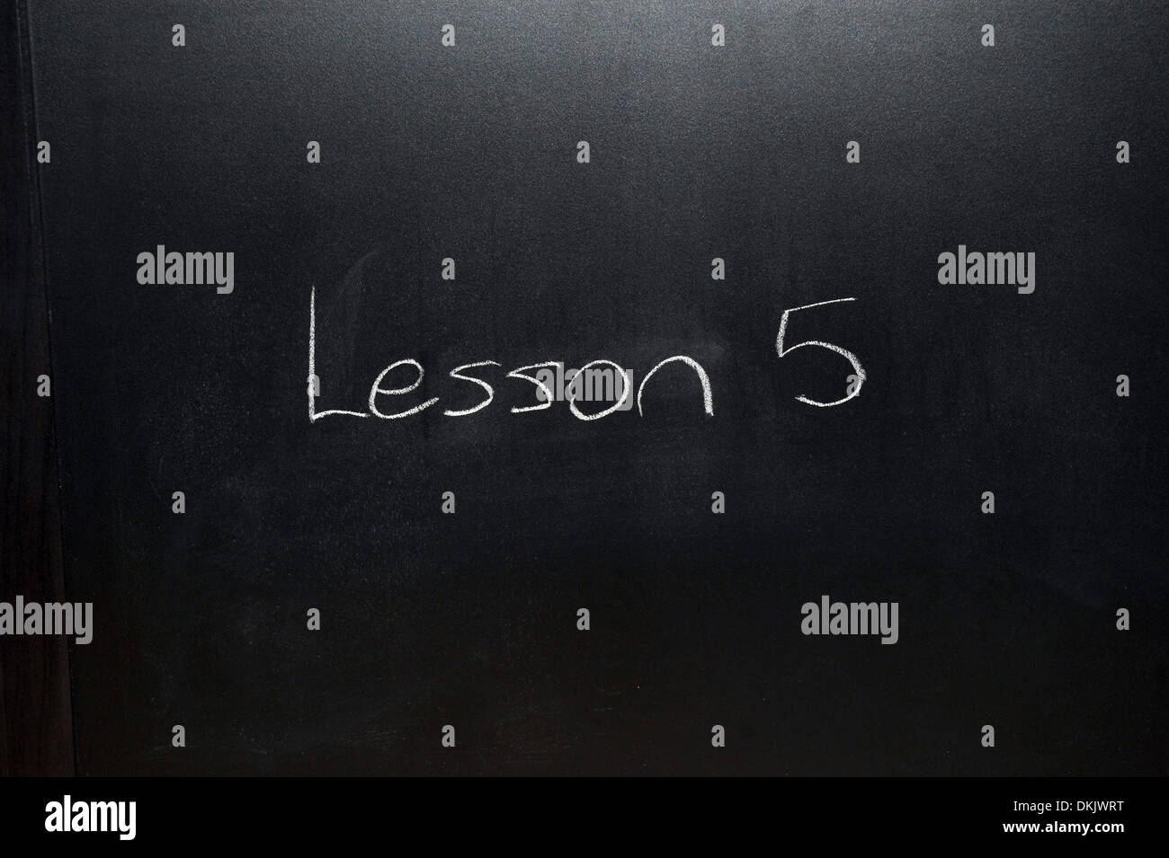 A blackboard with the word lesson 5 written on it in white chalk Stock ...