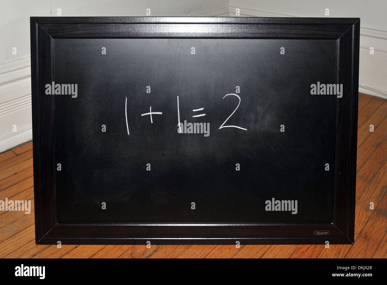 A blackboard with the sum 1+1=2 written on it in white chalk Stock ...