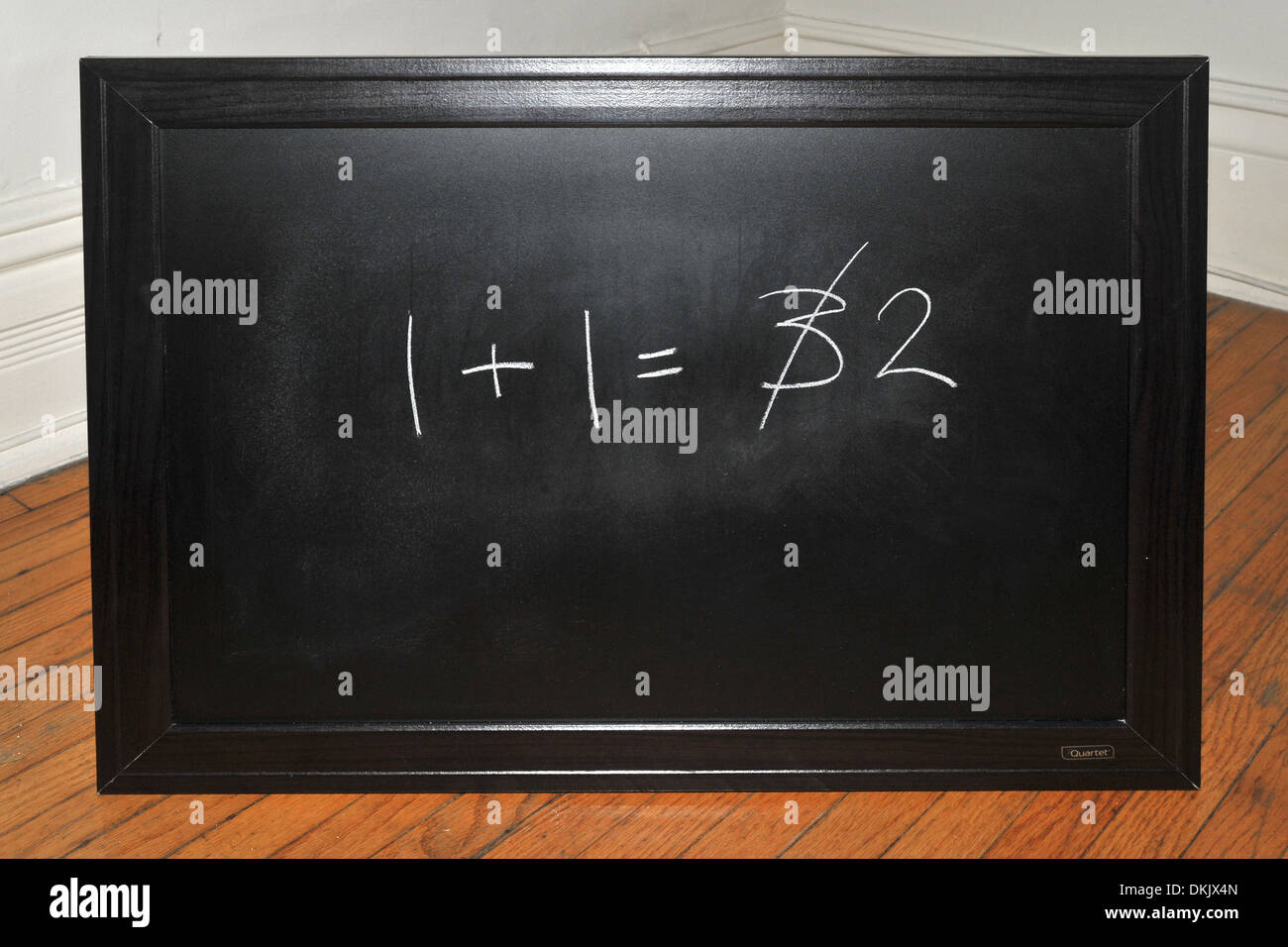 A blackboard with the sum 1+1= written on it in white chalk with ...