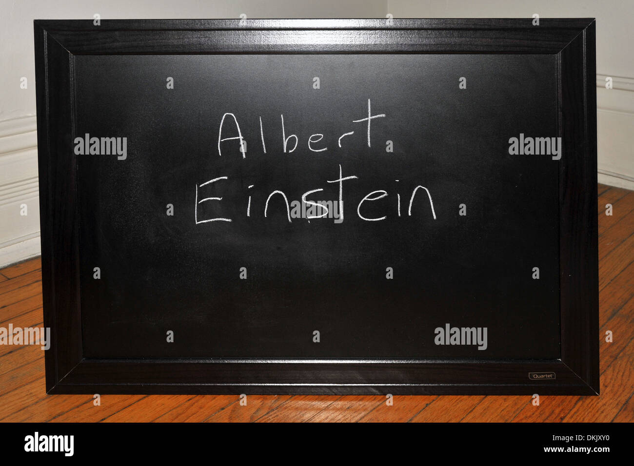A blackboard with the name Albert Einstein written on it in white chalk ...