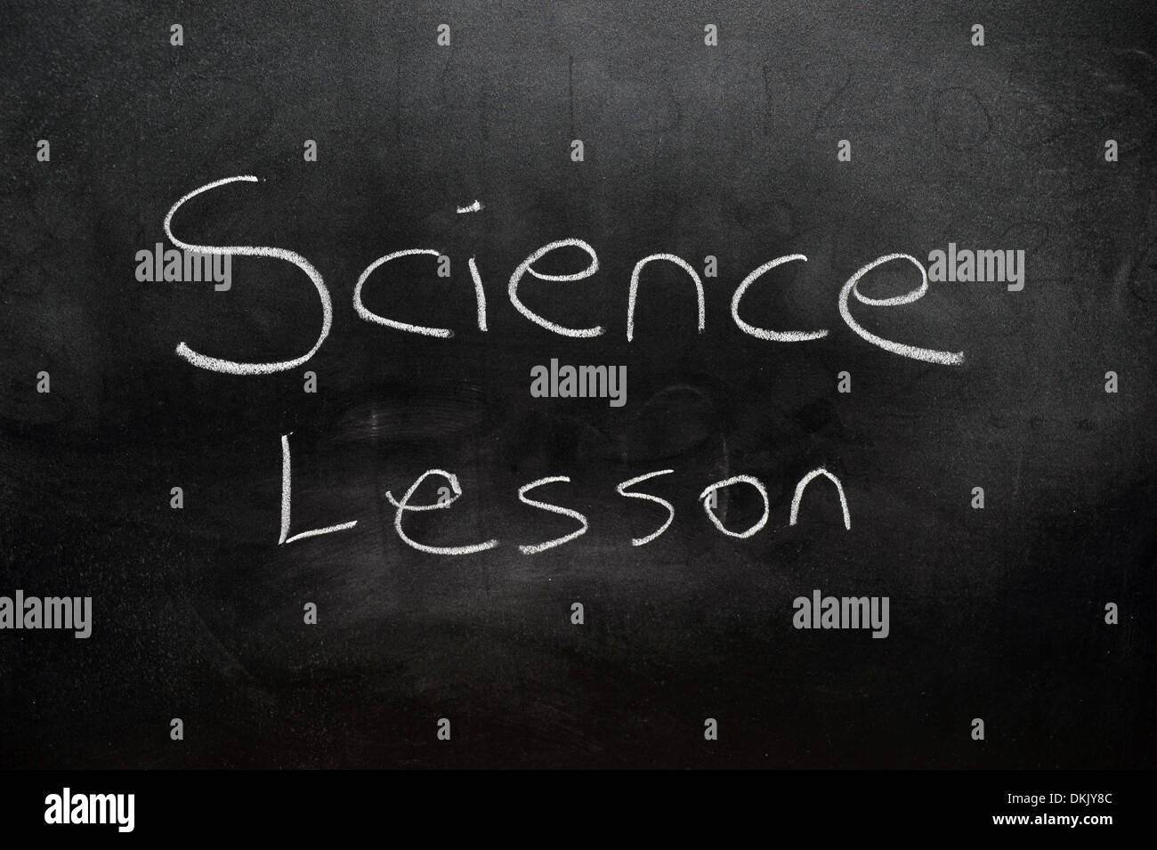 A blackboard with the words Science Lesson written on it in white chalk ...