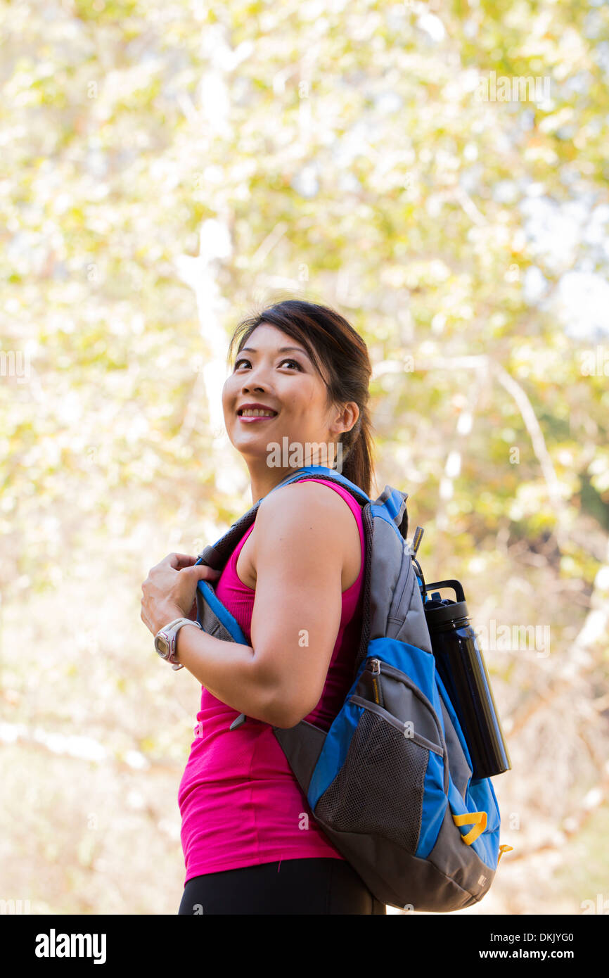 Female hiker looking over her shoulder Stock Photo - Alamy