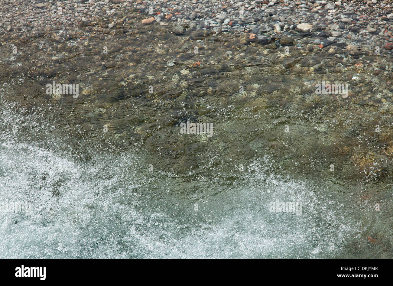 Wave breaking on pebbles Stock Photo - Alamy