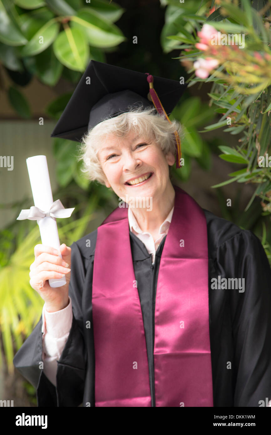 Elderly woman graduate holding degree Stock Photo - Alamy