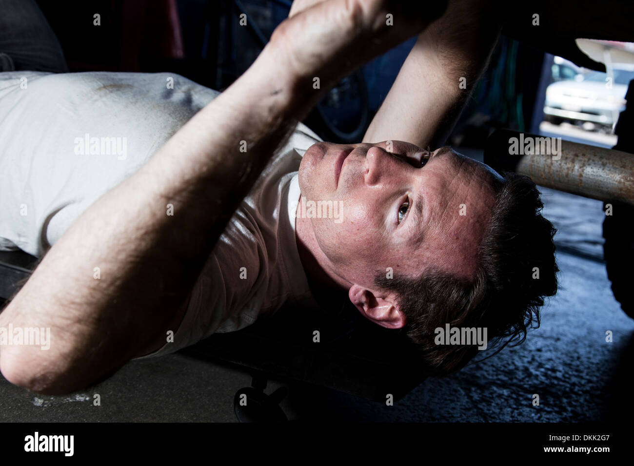 Man under car and garage hi-res stock photography and images - Alamy