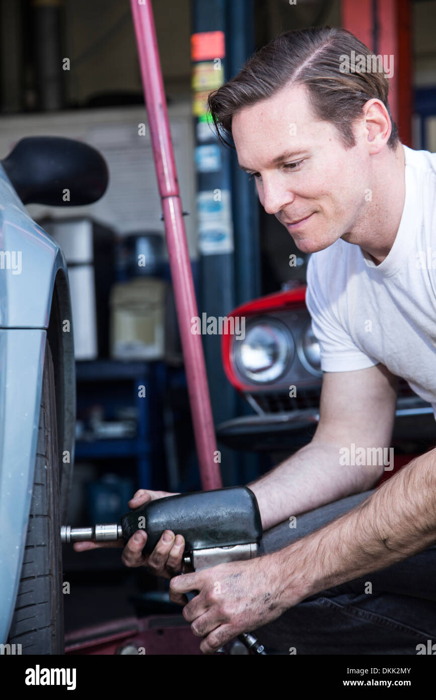 Male mechanic working on car Stock Photo - Alamy