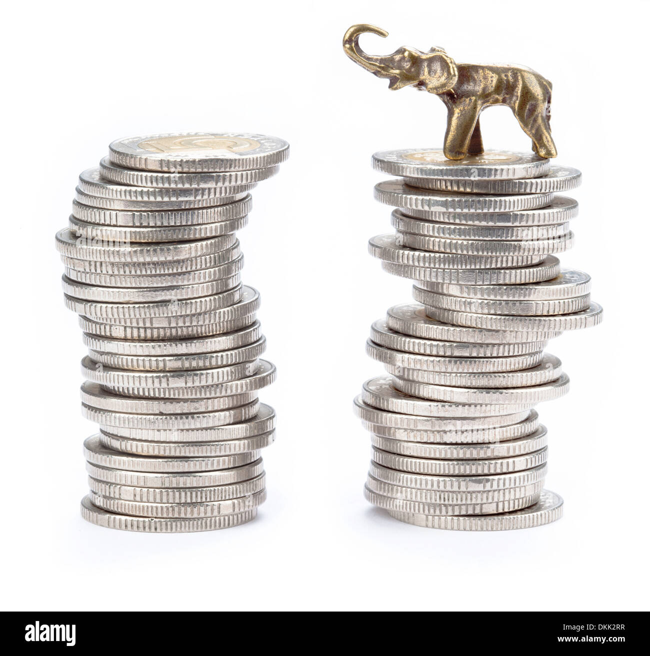 Two pyramids made with coins and lucky elephant Stock Photo - Alamy