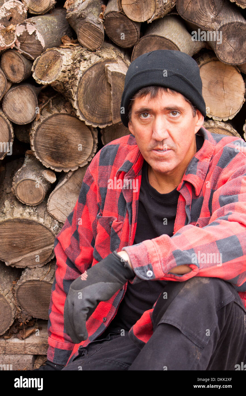 A middle aged man takes a break from splitting wood Stock Photo - Alamy