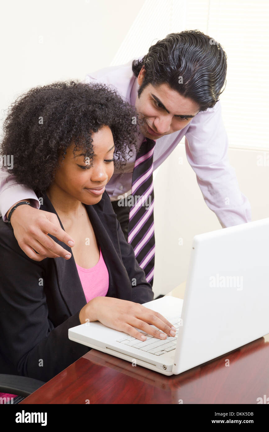 Business manager inappropriately touching female employee Stock Photo ...