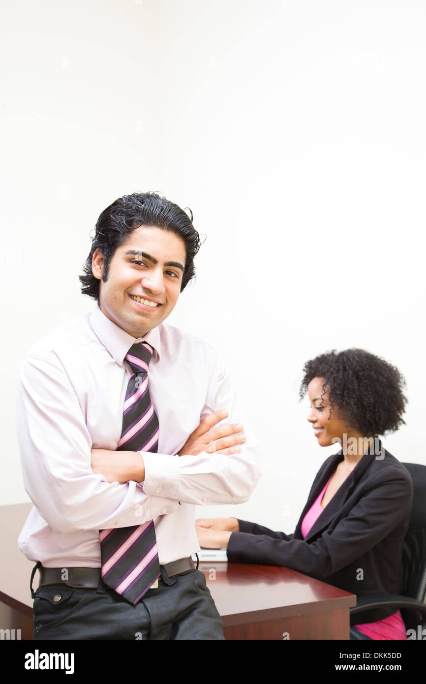 Female employee typing at her desk, supervisor smiling Stock Photo - Alamy