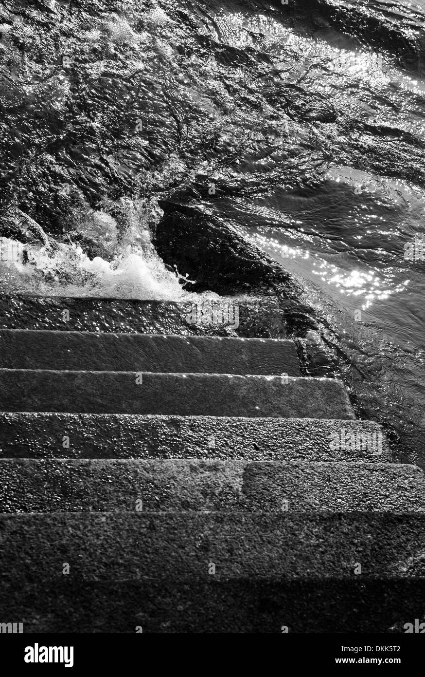Descending steps leading to splashing water Stock Photo - Alamy