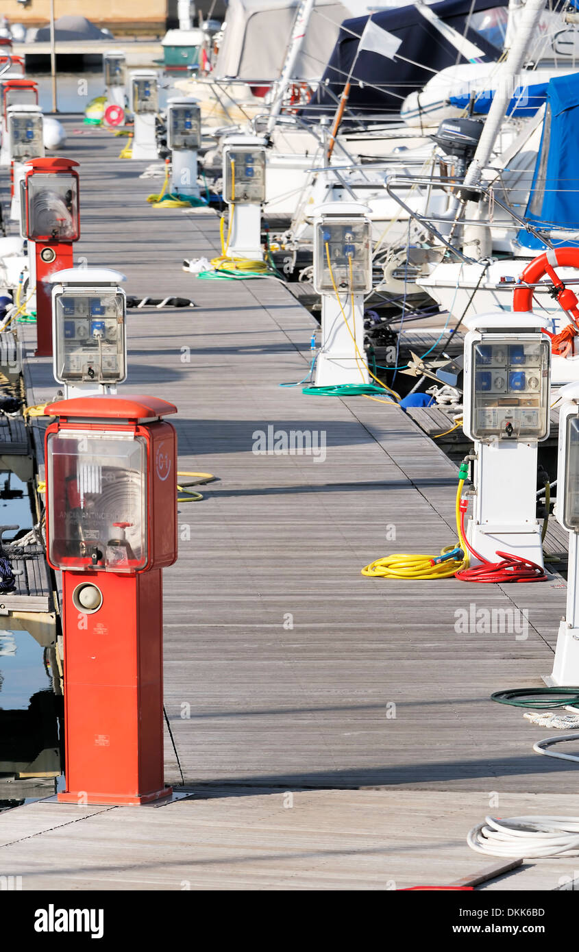 Pier with boats in a harbour Stock Photo - Alamy