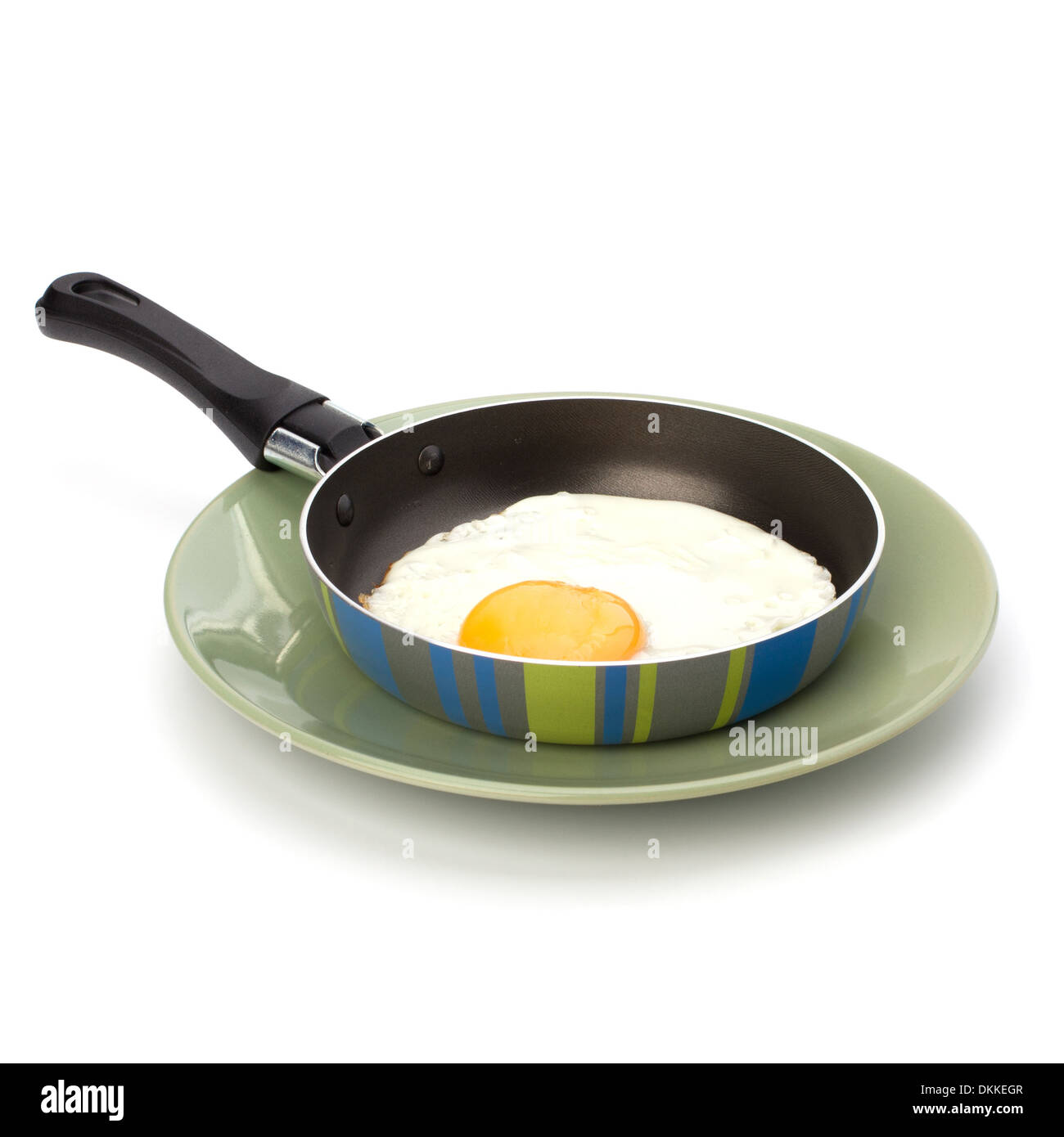 Fried egg on pan over white background Stock Photo - Alamy