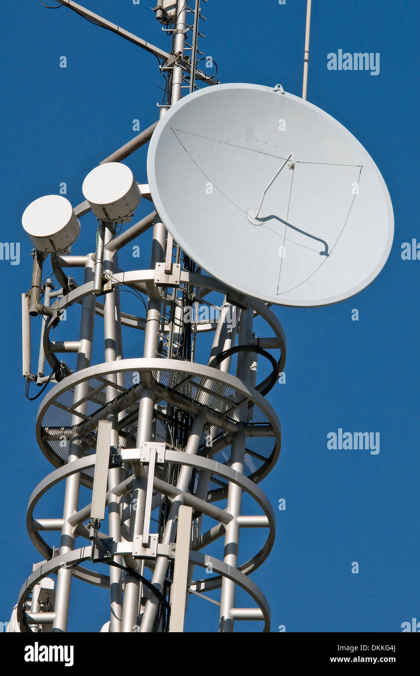 Transmission mast with parabolic antenna against a blue sky Stock Photo ...