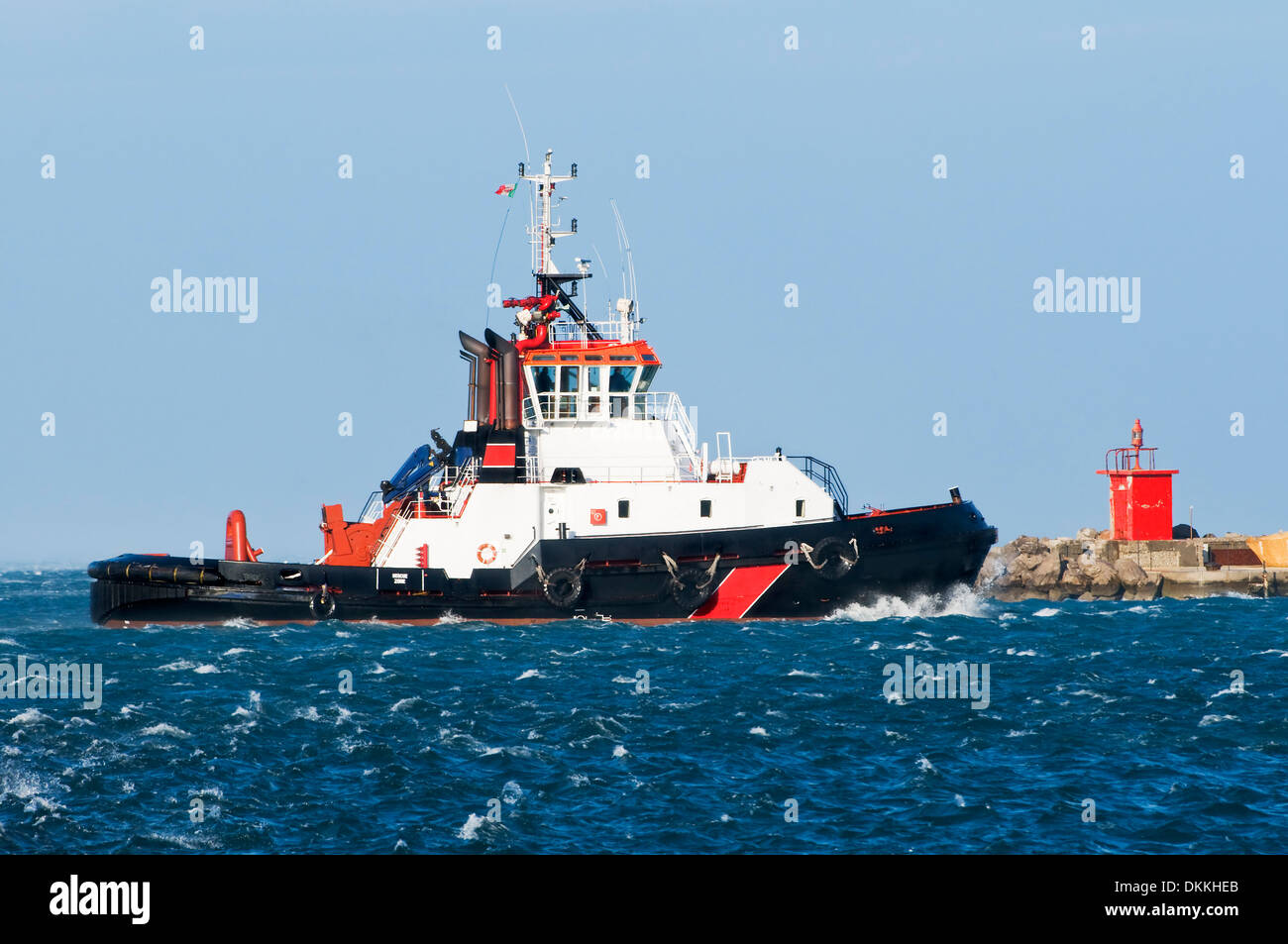 Tug boat navigating in a rough sea Stock Photo - Alamy