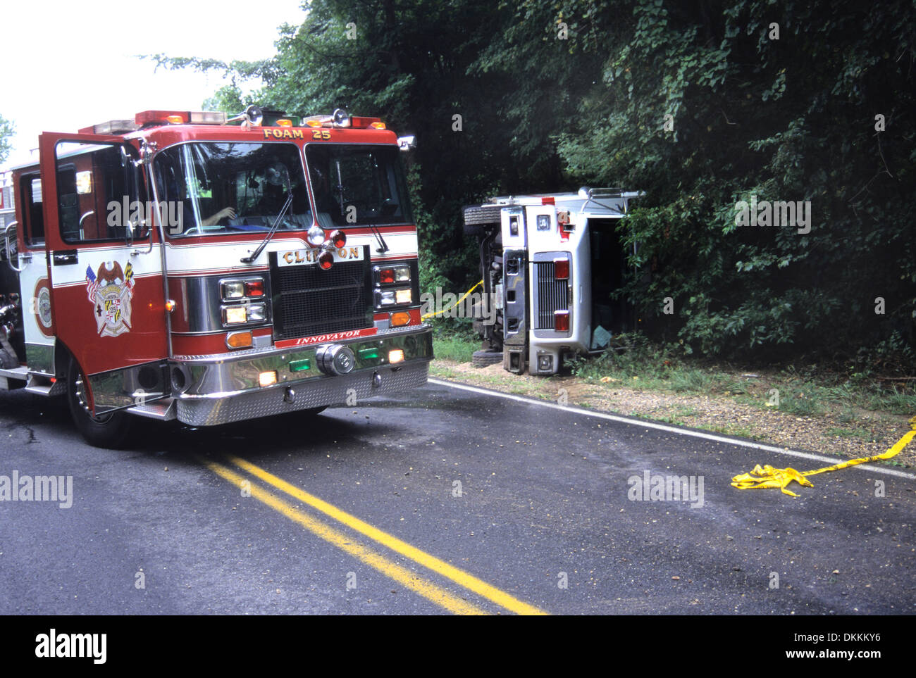 Fire truck on the scene of an ambulance thats flipped over and into the ...