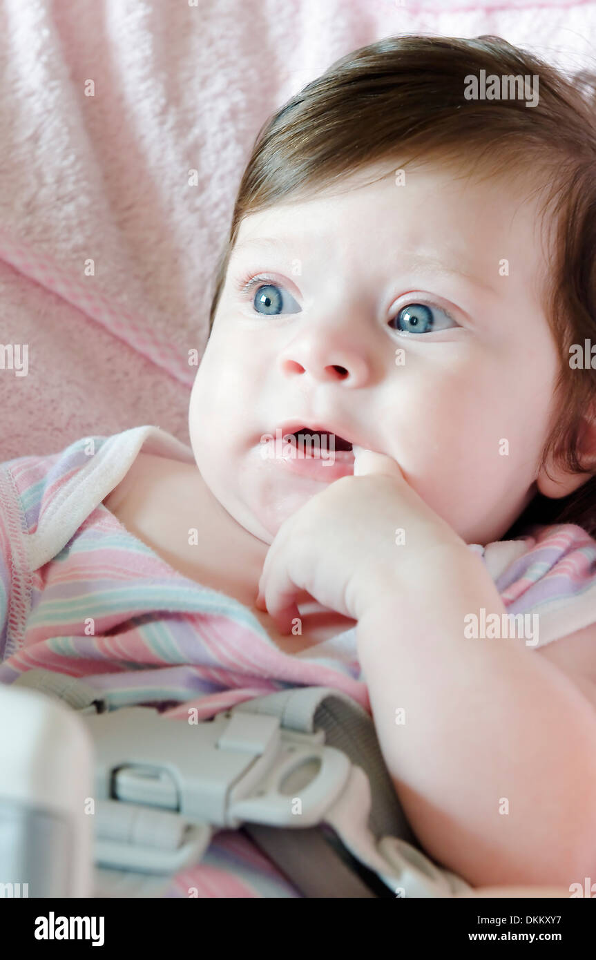 Baby-girl with finger in mouth watching something interesting Stock ...