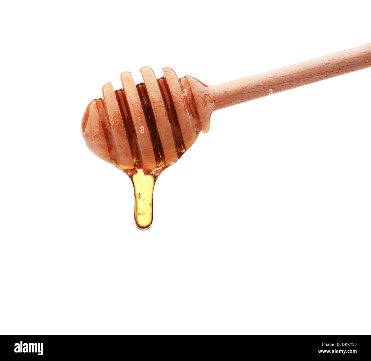 Honey Dripping From A Wooden Honey Dipper Isolated On White Background