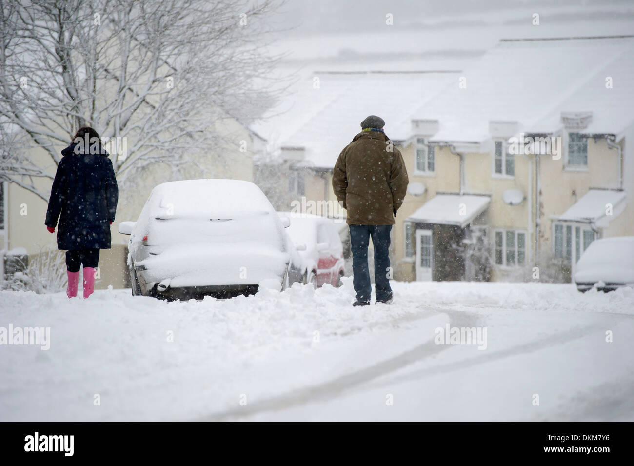 People walk through snow blocked roads during winter in village of ...