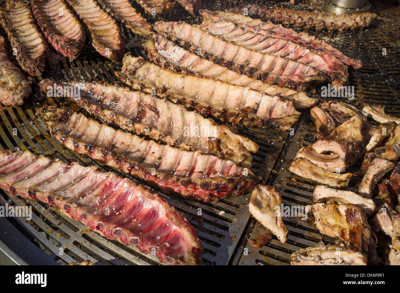 A massive amount of pork ribs on a charcoal grill Stock Photo - Alamy