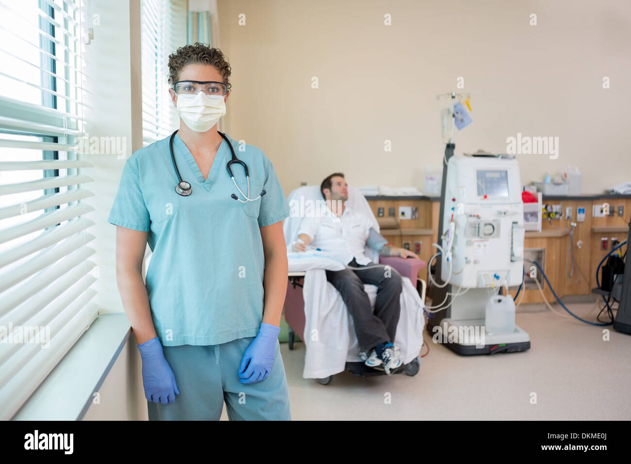 Nurse In Protective Clothing With Patient Receiving Dialysis Stock ...