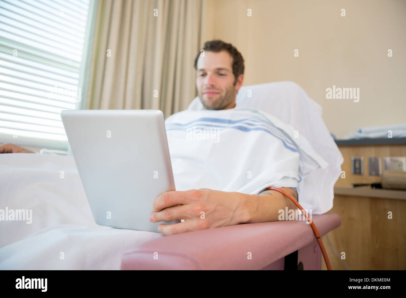 Patient Using Tablet Computer During Renal Dialysis Stock Photo - Alamy