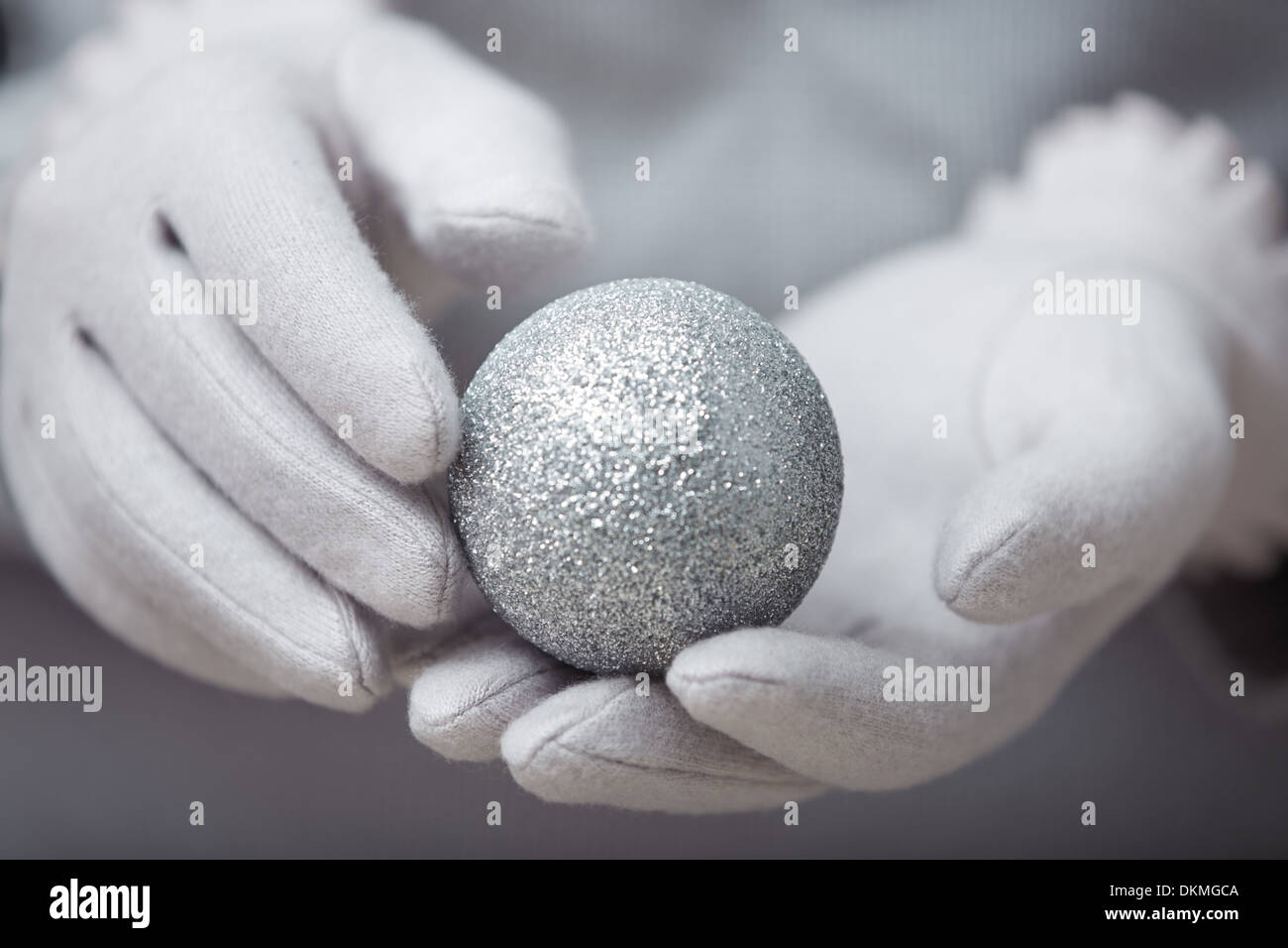 Human hands in warm mittens throwing Christmas ball Stock Photo - Alamy