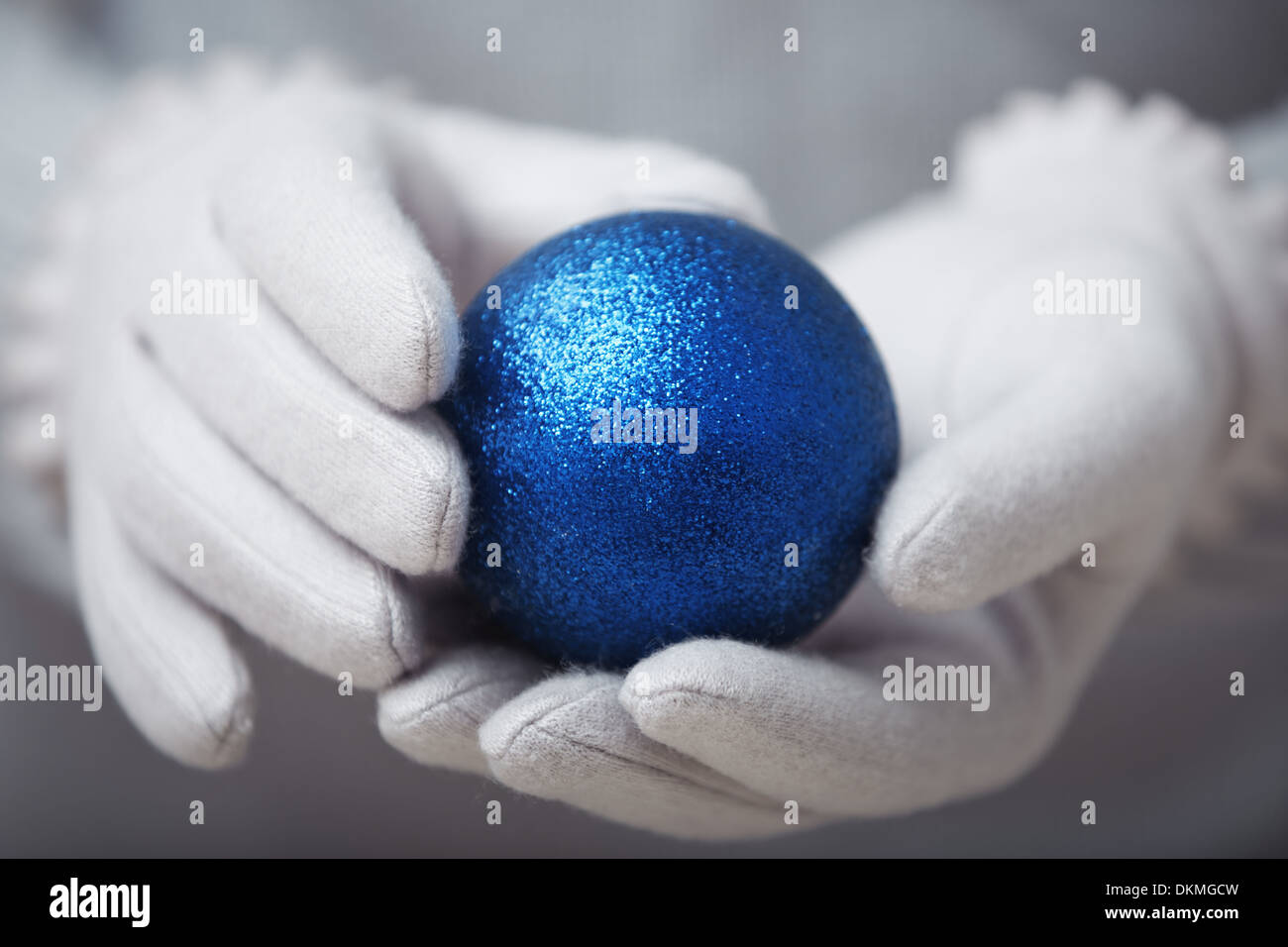 Human hands in warm mittens throwing Christmas ball Stock Photo - Alamy