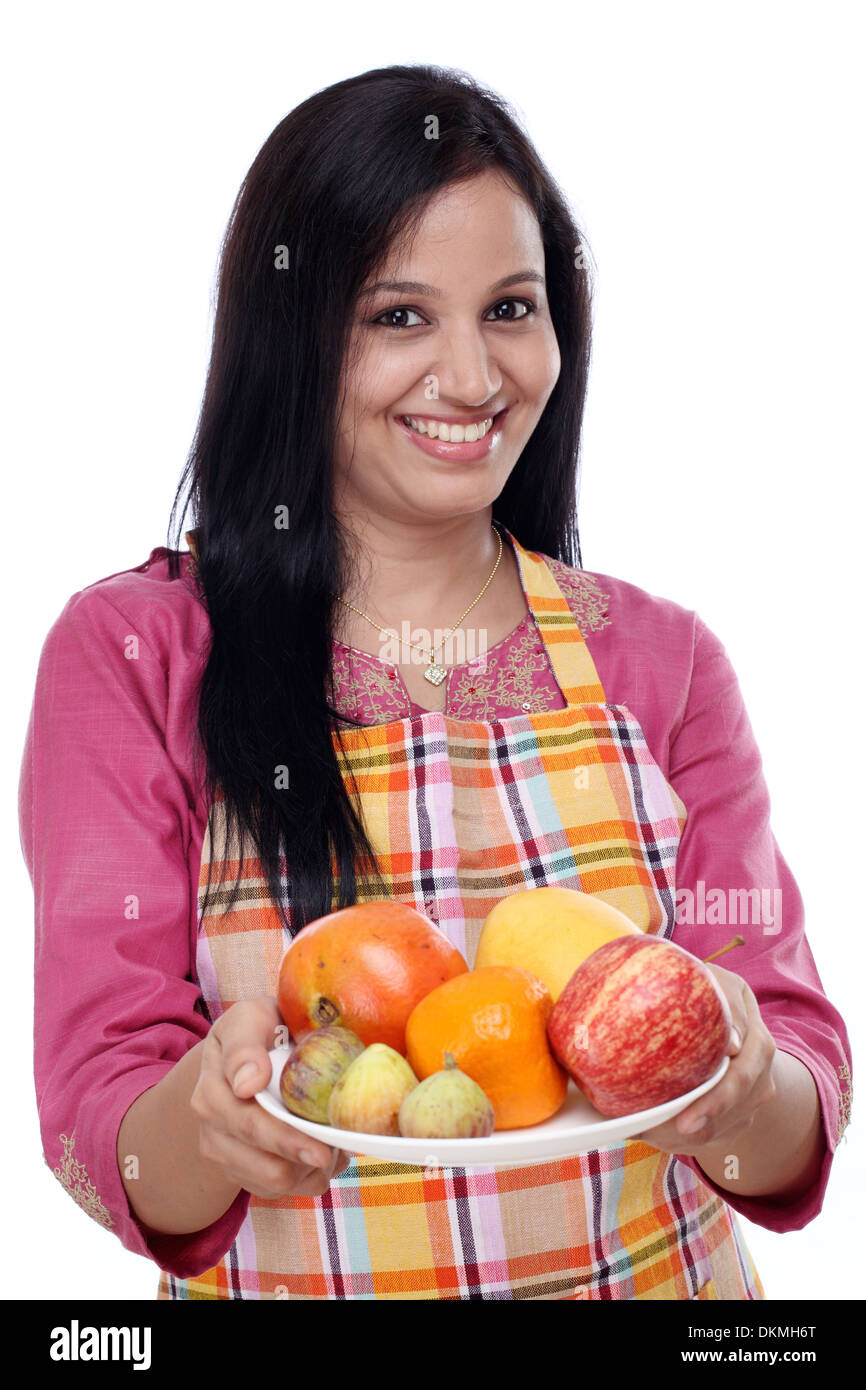 Young happy smiling woman with plate of fruits Stock Photo - Alamy