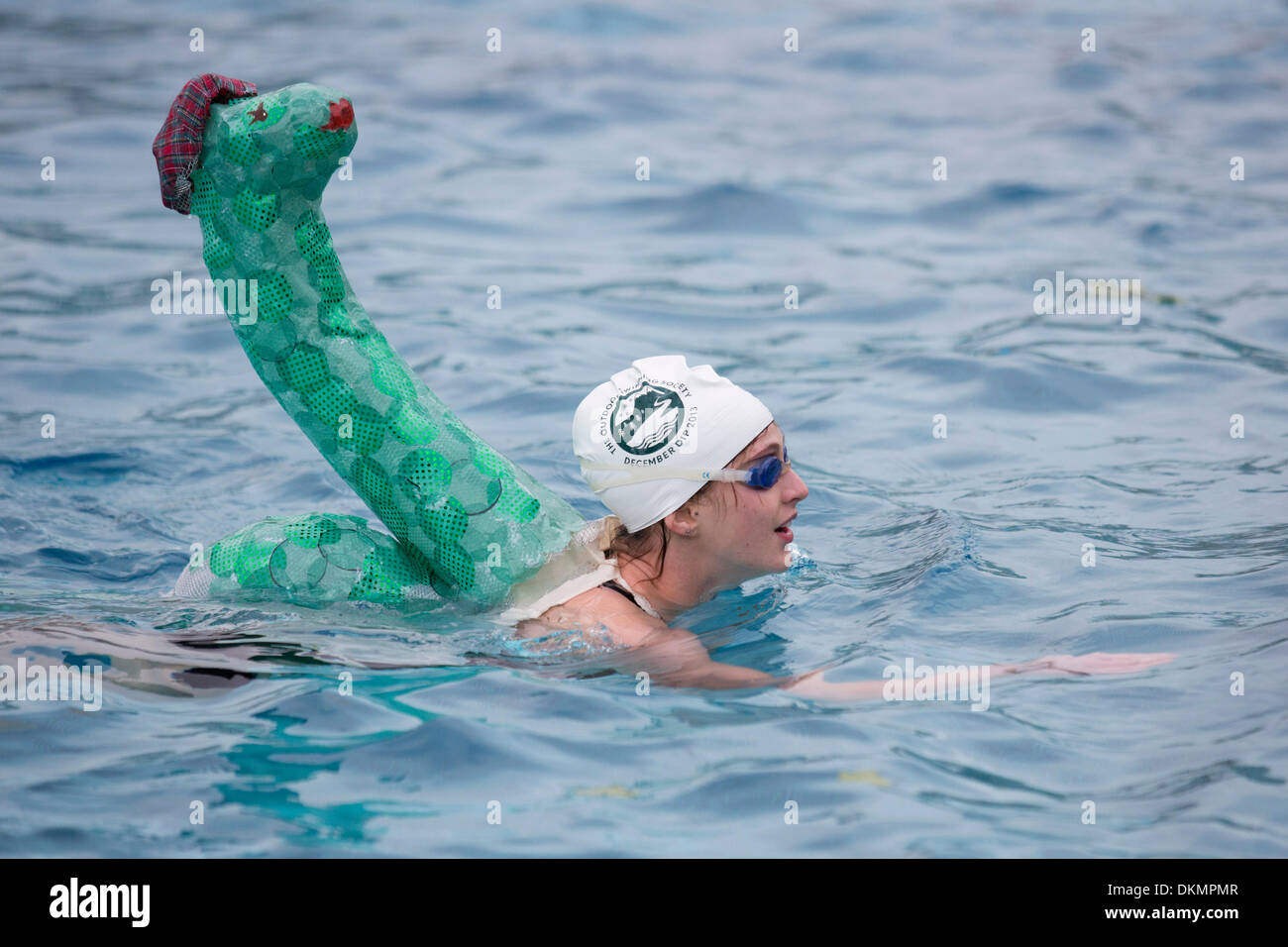 London, UK. 7 December 2013. Woman with a Nessie costume. Several ...