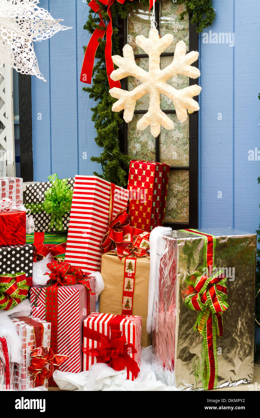 Large presents wrapped in colorful papers with bows in a pile ready for ...