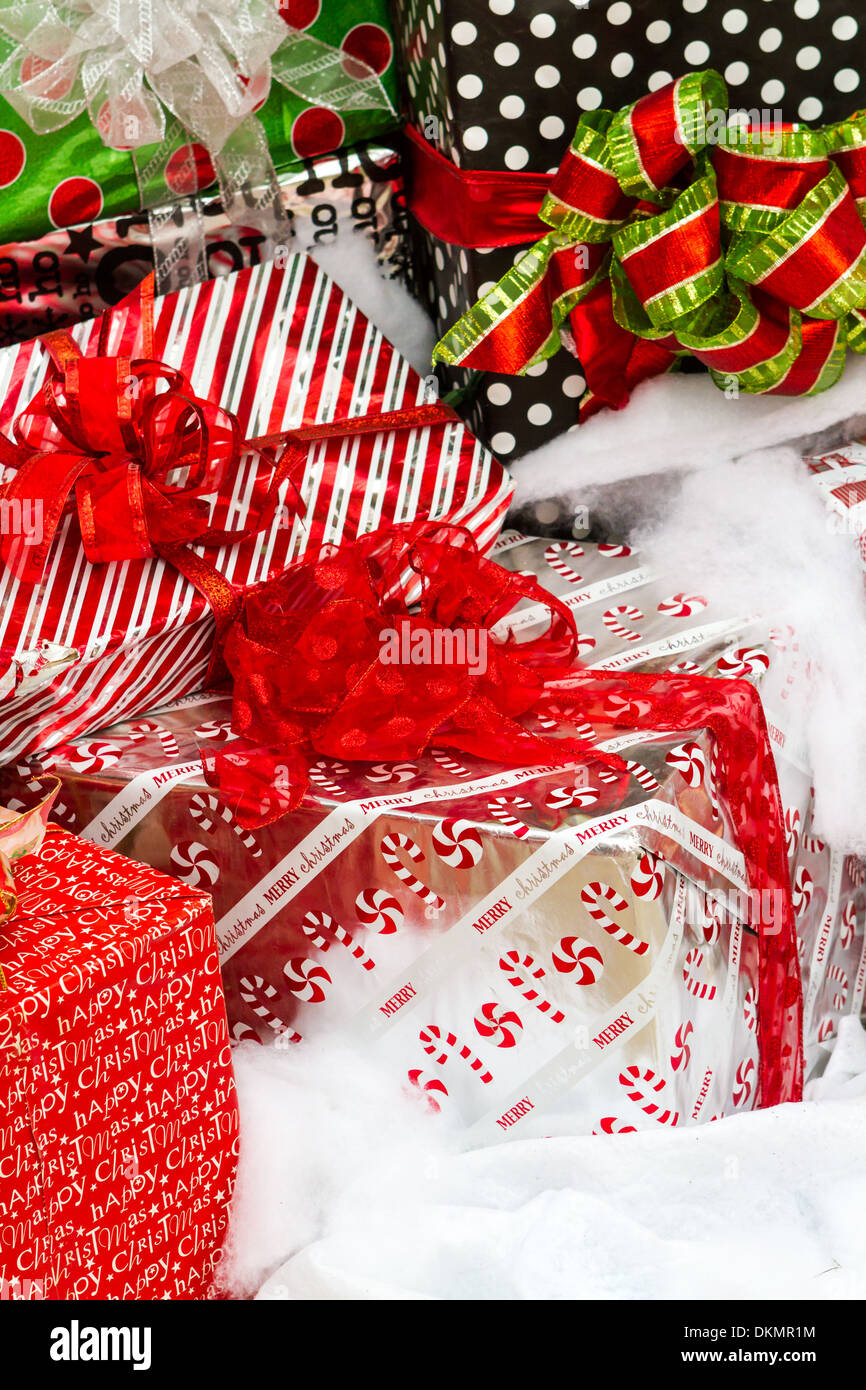 Large presents wrapped in colorful papers with bows in a pile ready for ...