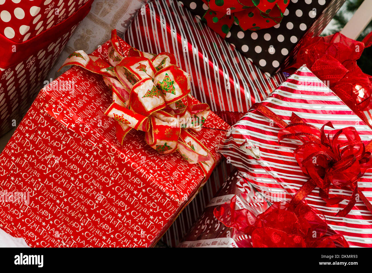Large presents wrapped in colorful papers with bows in a pile ready for ...